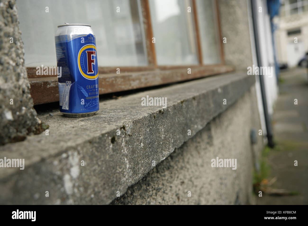 Empty and squashed can of Foster's lager left on house windowsill ...