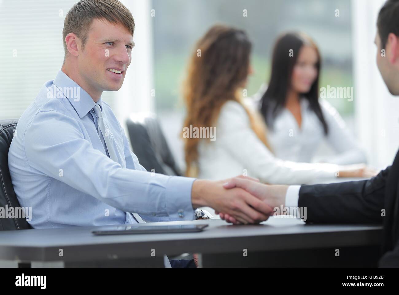 handshake business partners at your Desk Stock Photo - Alamy