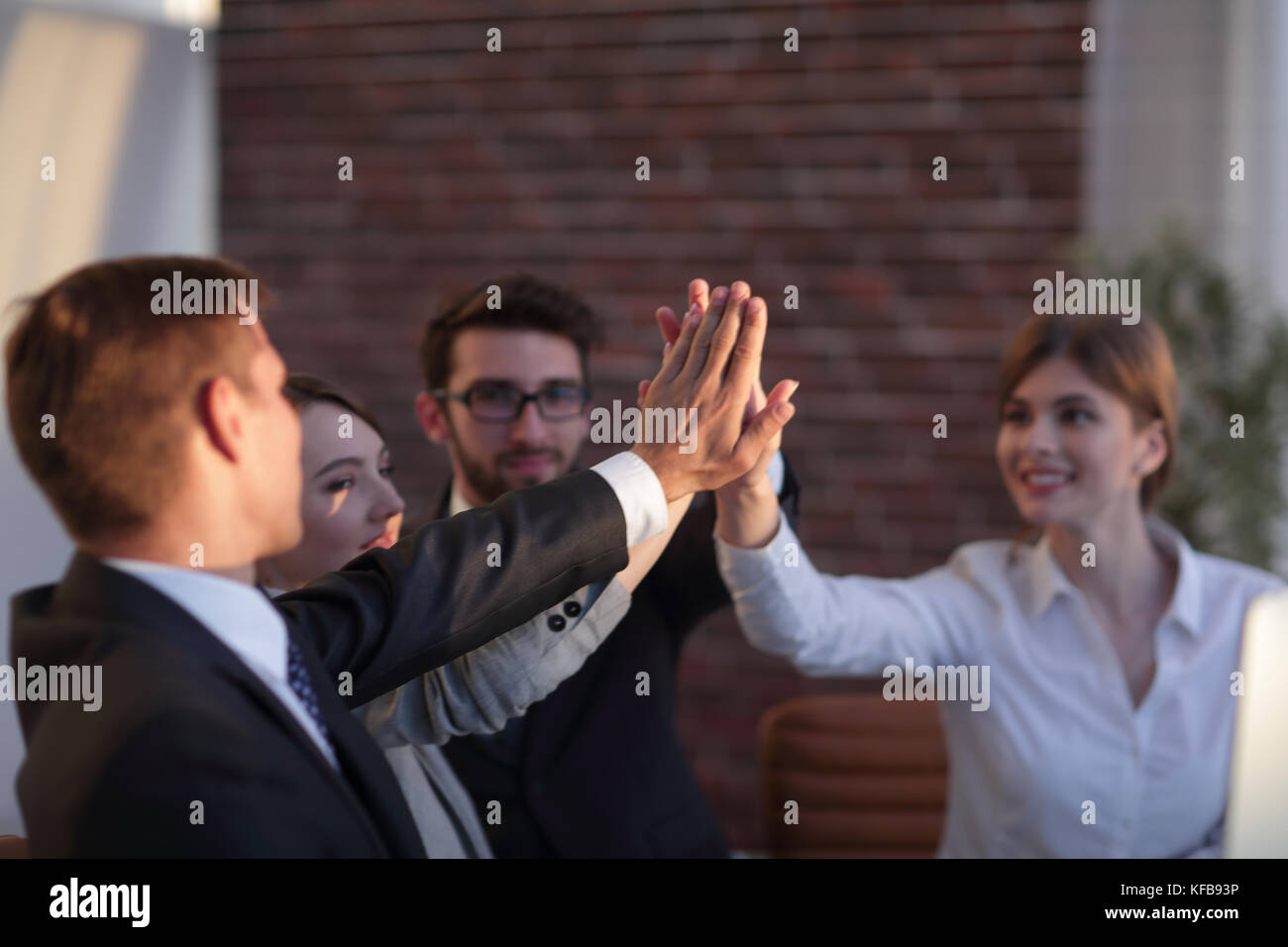 successful business team giving each other a high five Stock Photo - Alamy