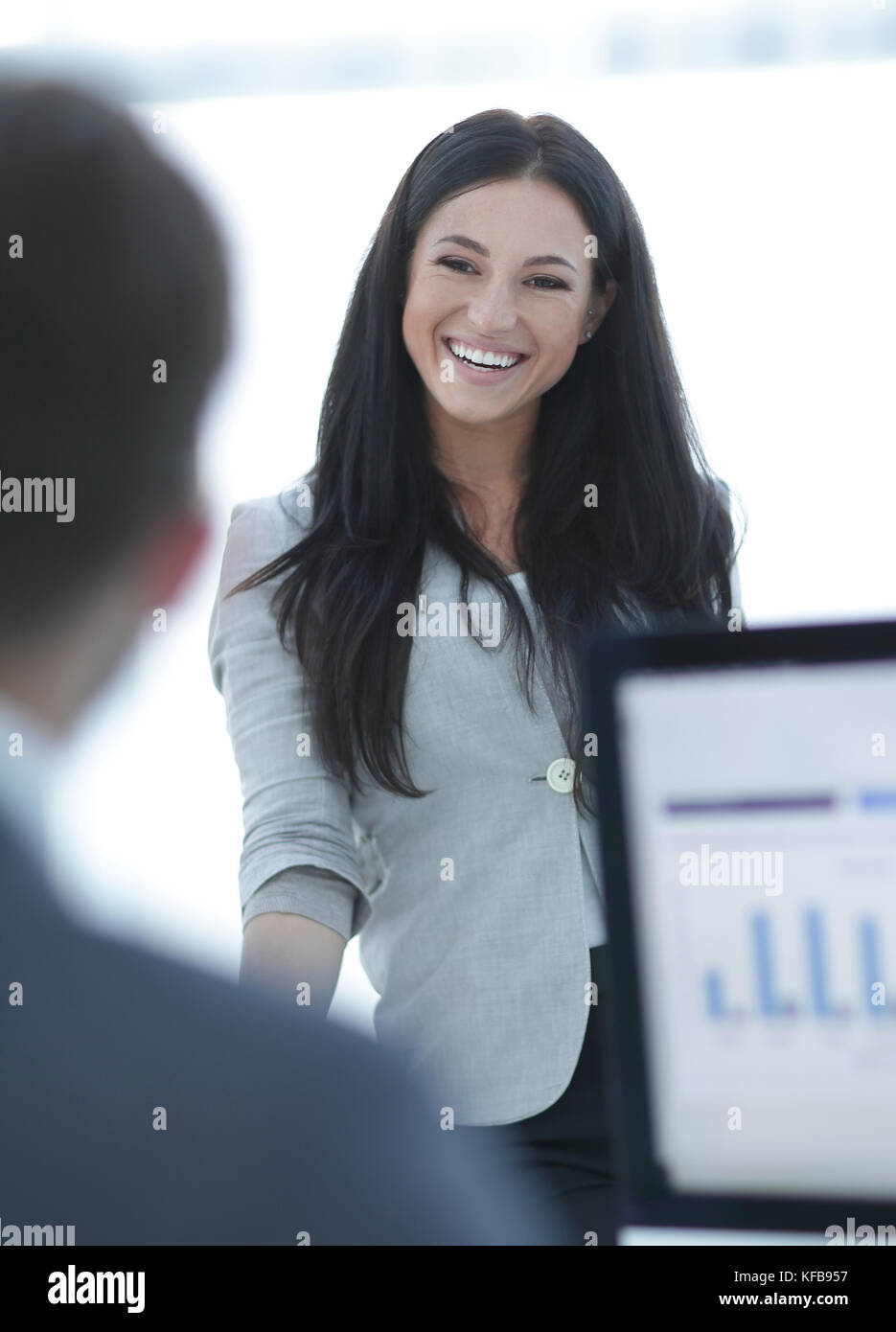 Modern business woman standing near a work table in the office Stock ...