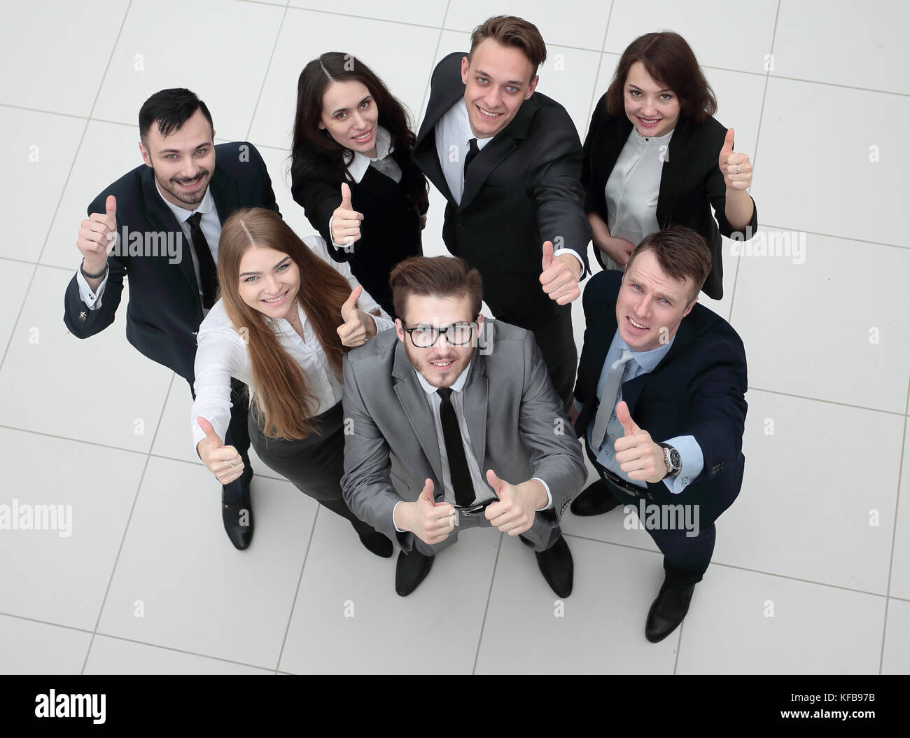 group of successful employees showing thumbs up Stock Photo - Alamy