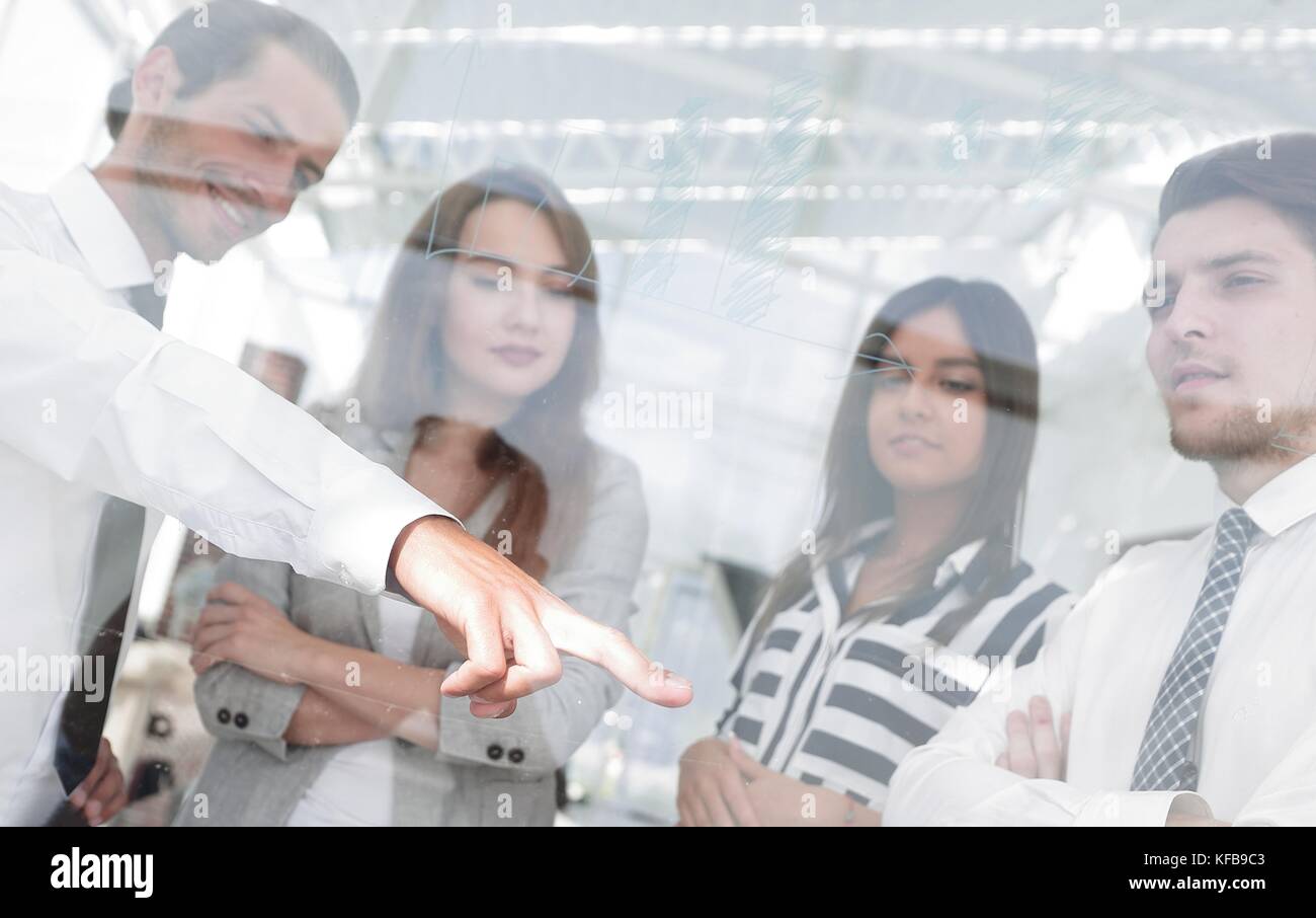 from behind the glass.successful business team Stock Photo - Alamy