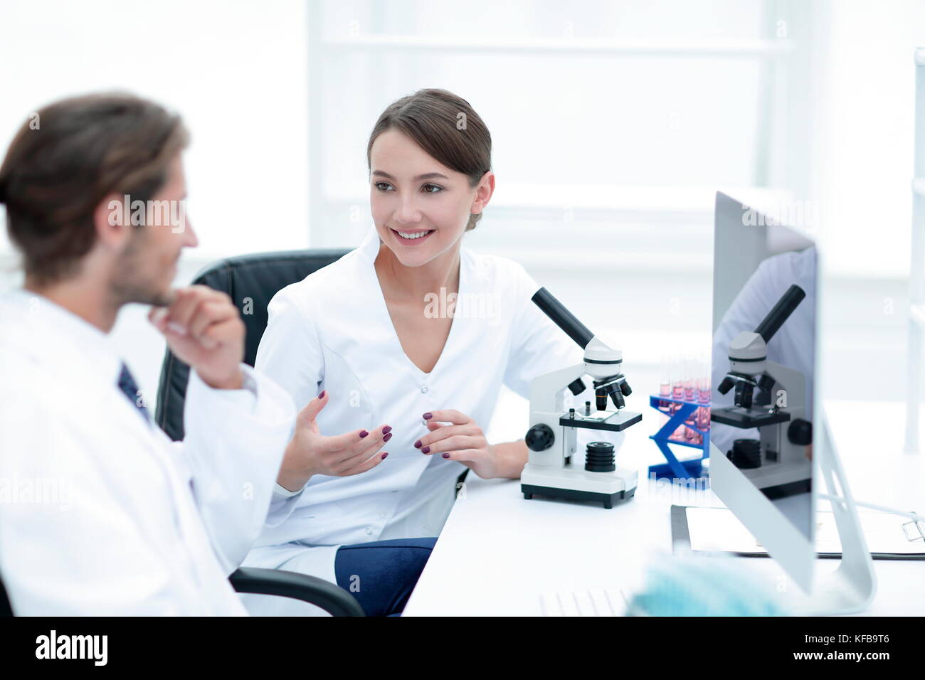 Side view of two scientists conducting a chemical experiment Stock ...