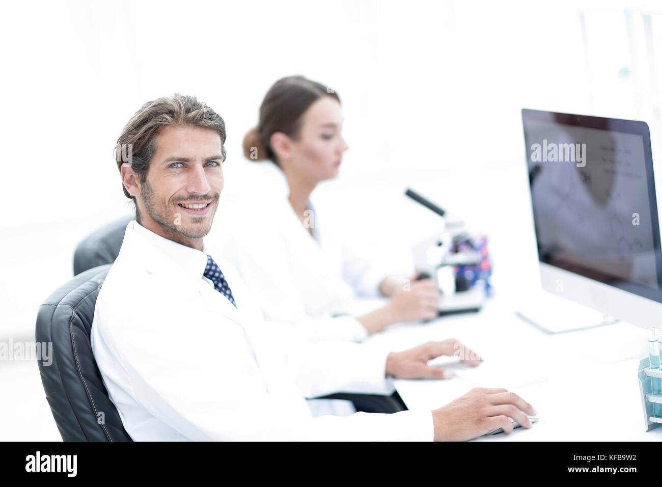 Young male technician working on computer in laboratory Stock Photo - Alamy