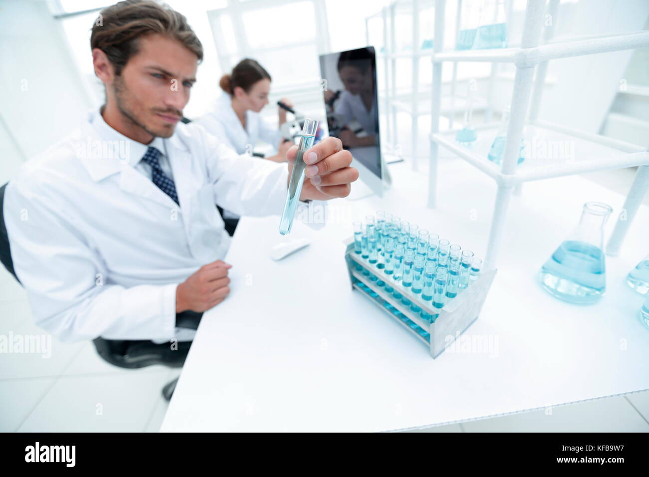 Busy group of researchers carrying out experiments Stock Photo - Alamy