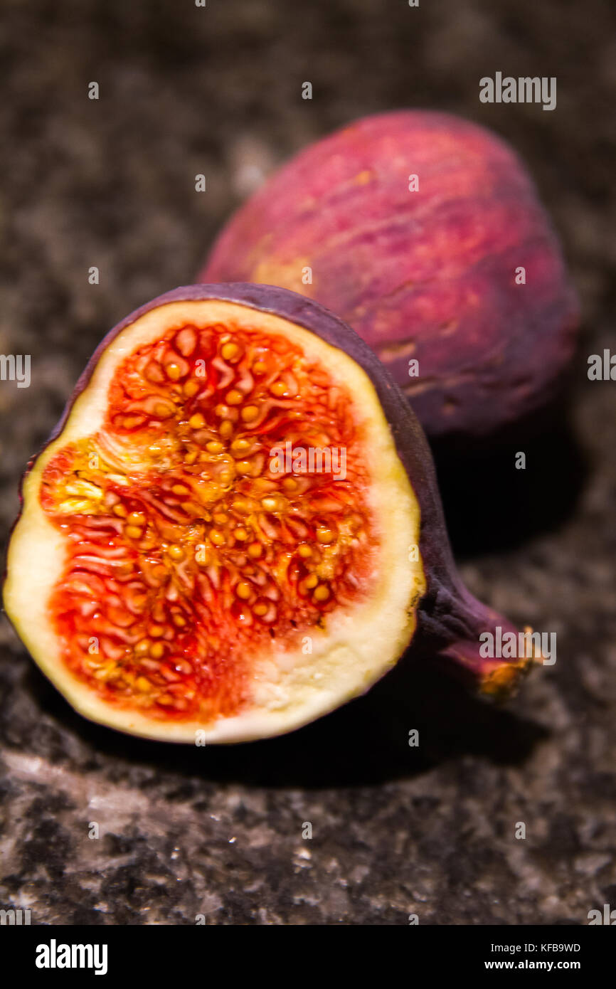 Macro of ripe common fig (Ficus carica) fruit over dark background ...