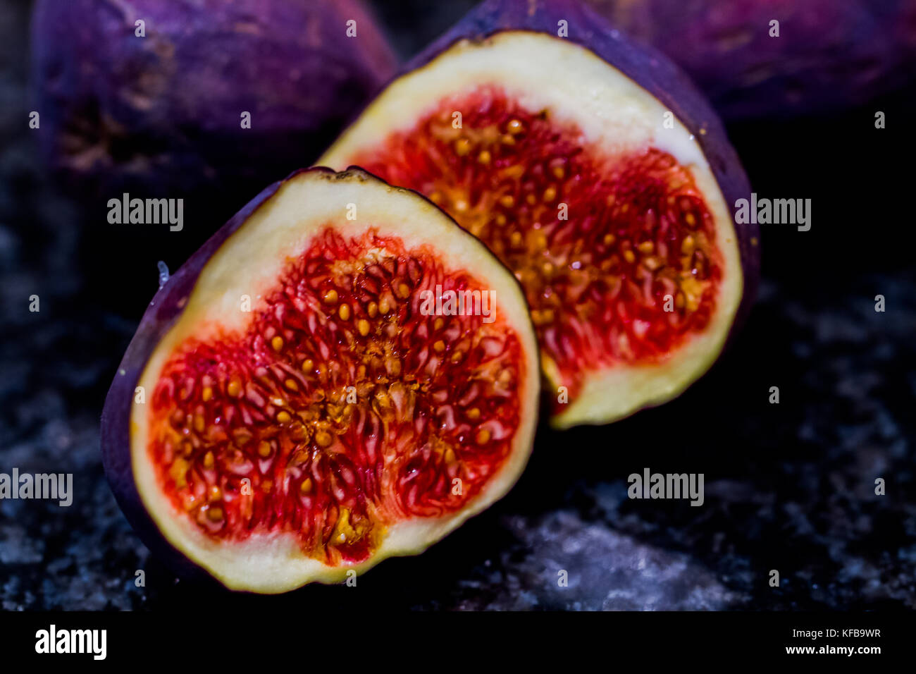 Macro of ripe common fig (Ficus carica) fruit over dark background ...