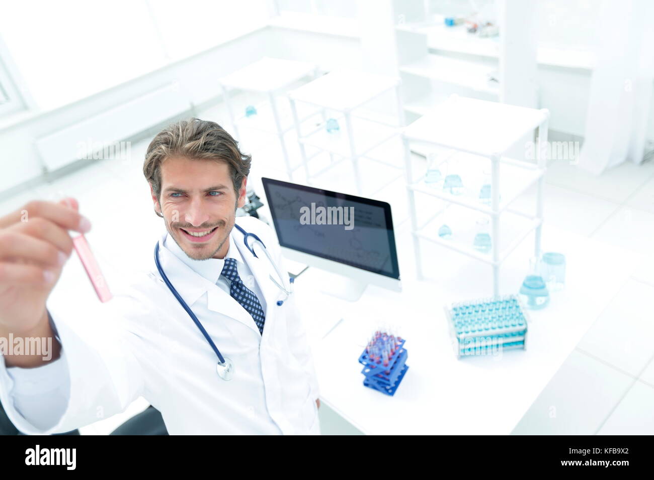 Man in laboratory checking test tubes Stock Photo - Alamy