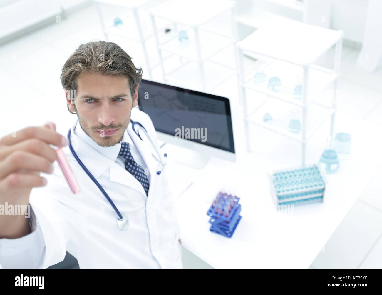 Man in laboratory checking test tubes Stock Photo - Alamy