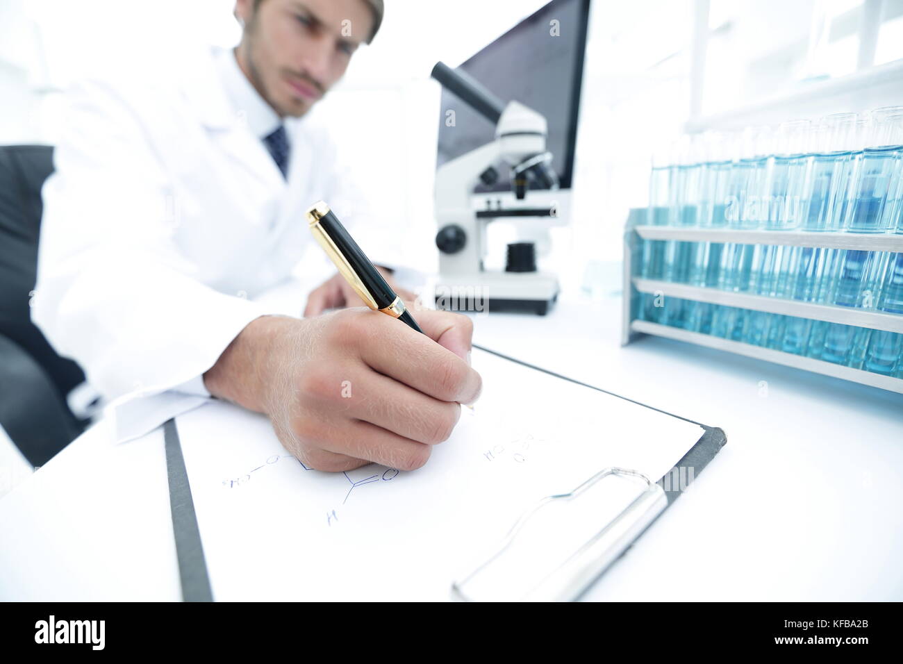 scientist makes a note of experiment in the laboratory Stock Photo - Alamy