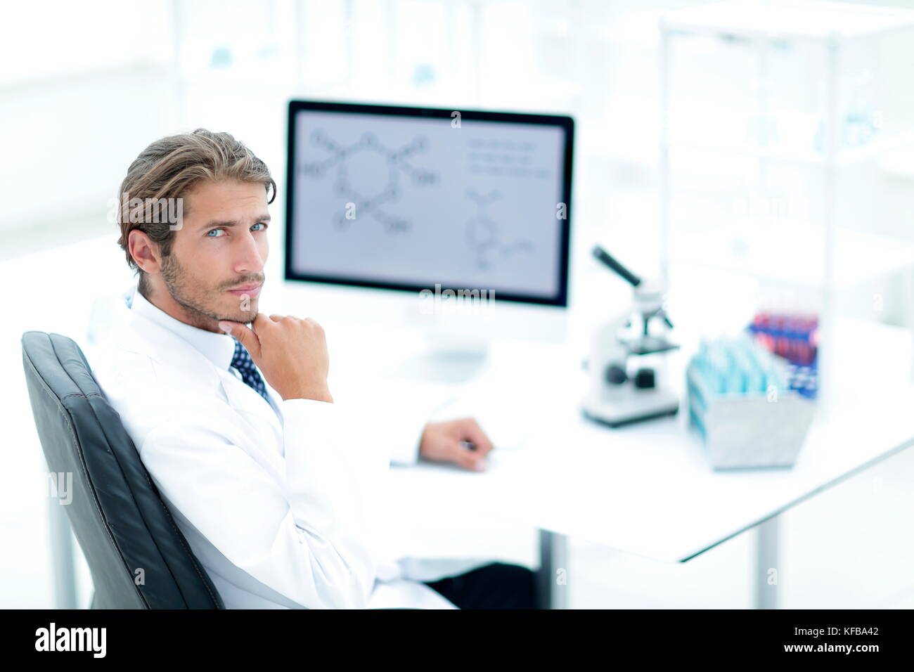 Scientist using computer and microscope in the laboratory Stock Photo ...