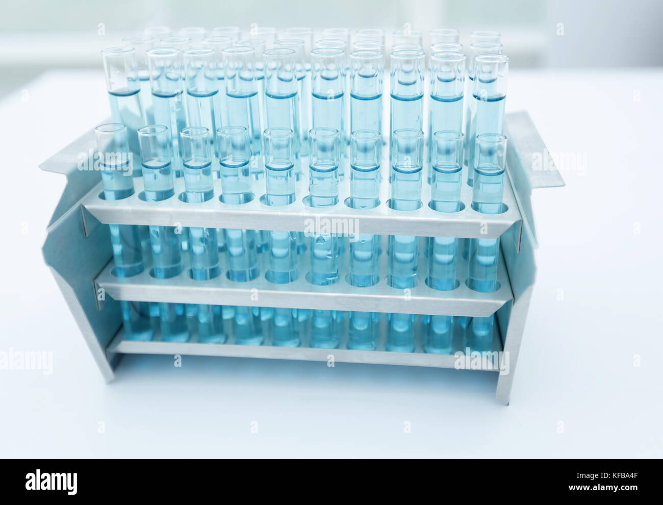 Blue water in a transparent test-tube on light background Stock Photo ...
