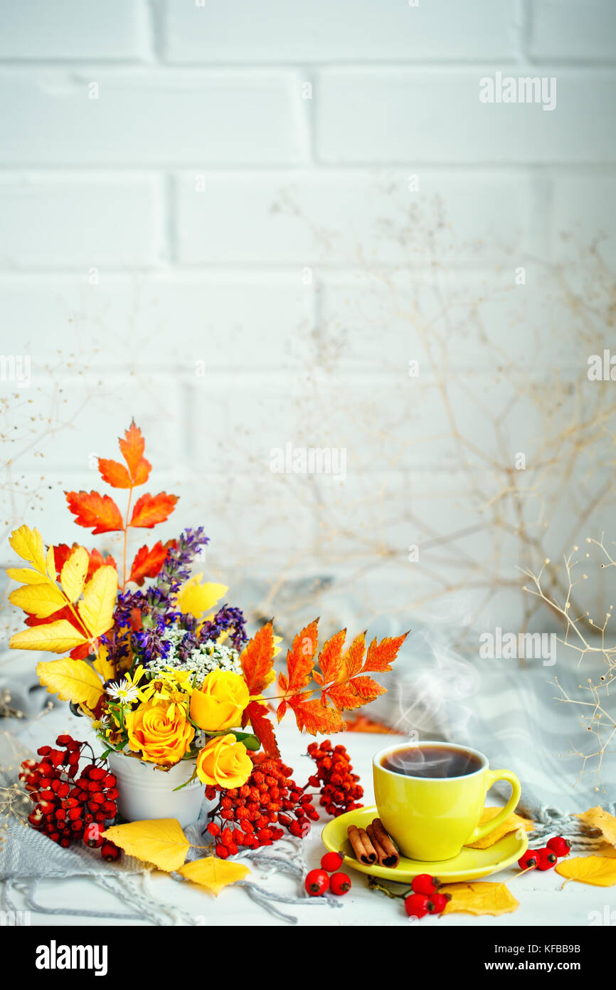 Cup of coffee, autumn leaves and flowers on a wooden table. Autumn ...