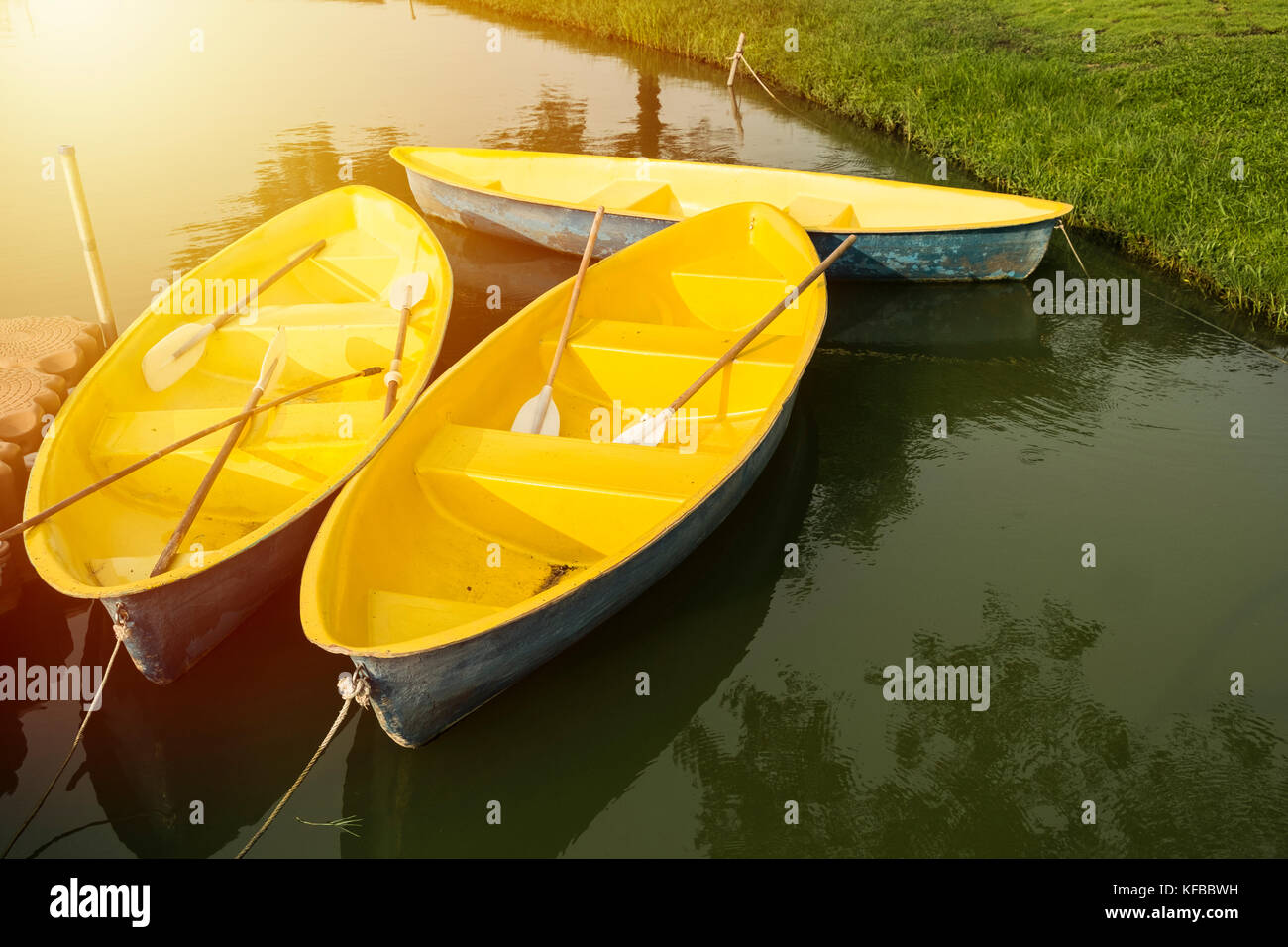 Three yellow boats parked at the waterfront in the morning Stock Photo ...