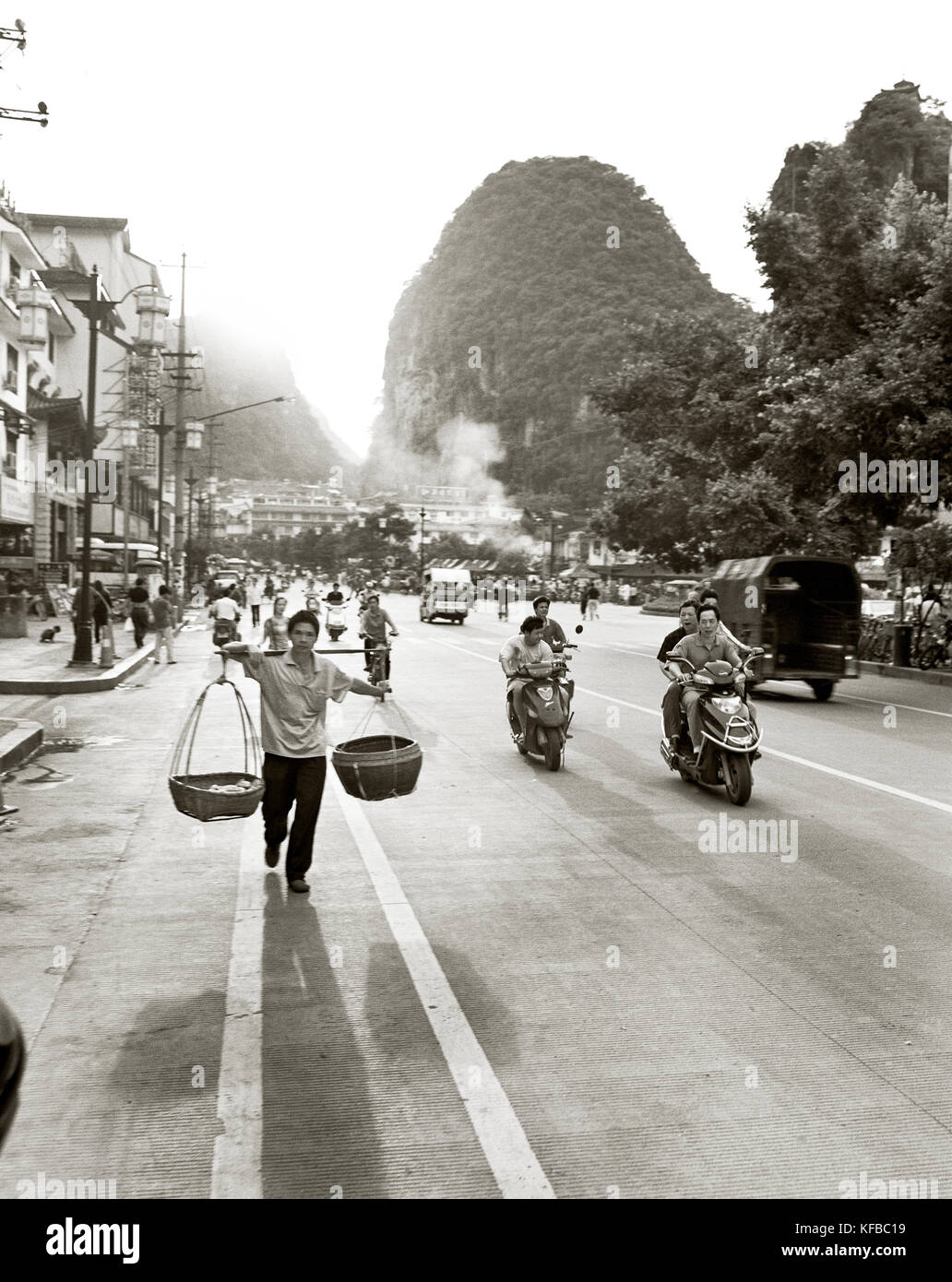 CHINA, Guilin, people work, walk and ride motorbikes on the streets of ...