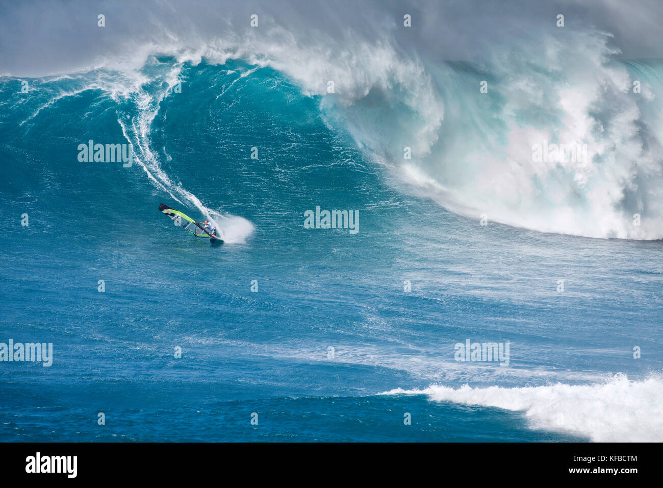 USA, Hawaii, Maui, a man windsurfs on huge waves at a break called Jaws ...