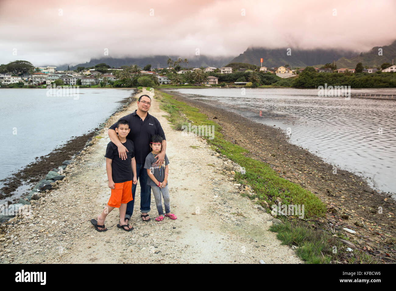 USA, Oahu, Hawaii, Jujitsu martial arts fighter Keith Chang with his ...