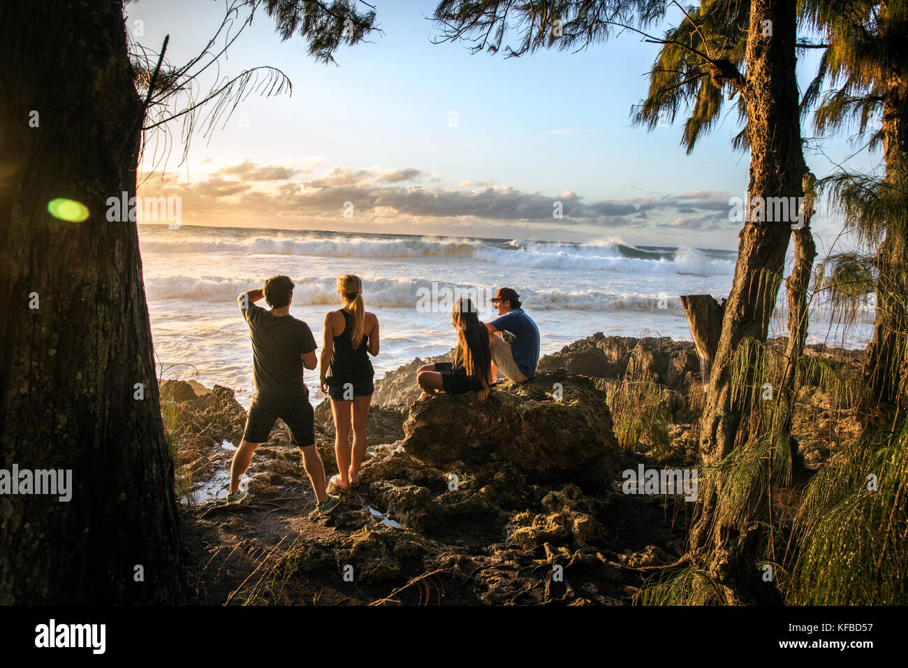 HAWAII, Oahu, North Shore, bystanders watch a big swell roll in at ...