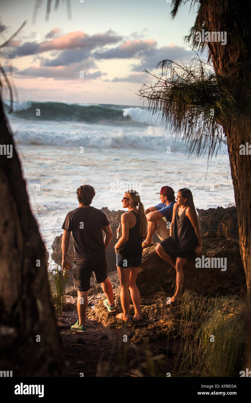 HAWAII, Oahu, North Shore, bystanders watch a big swell roll in at ...