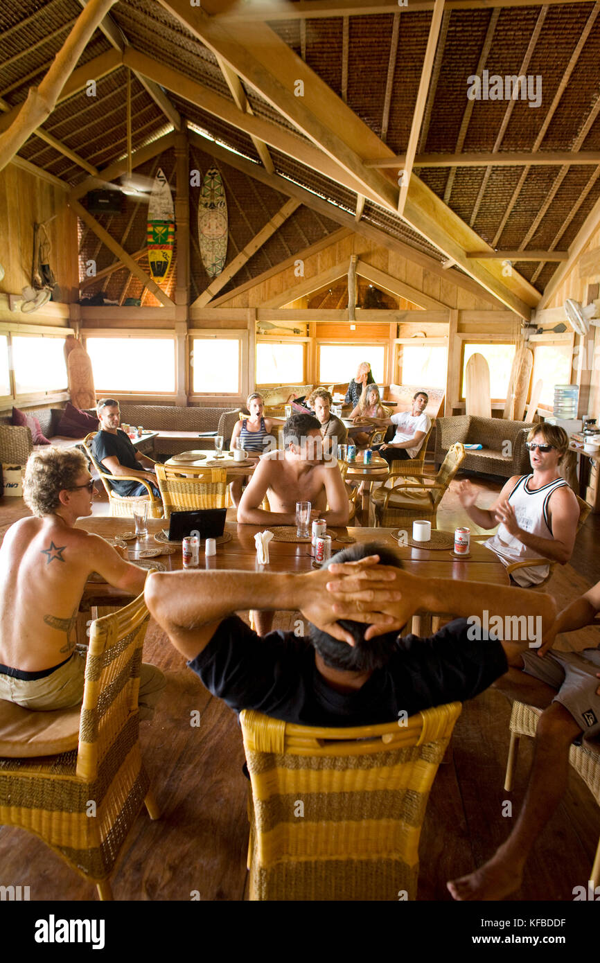 INDONESIA, Mentawai Islands, Kandui Resort, people having a meal in the ...