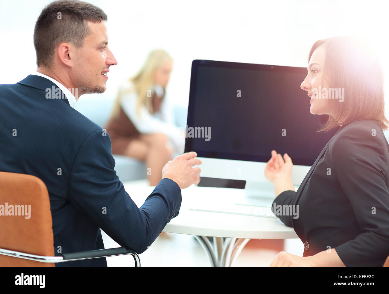 Portrait of smart business partners using computer at meeting Stock ...