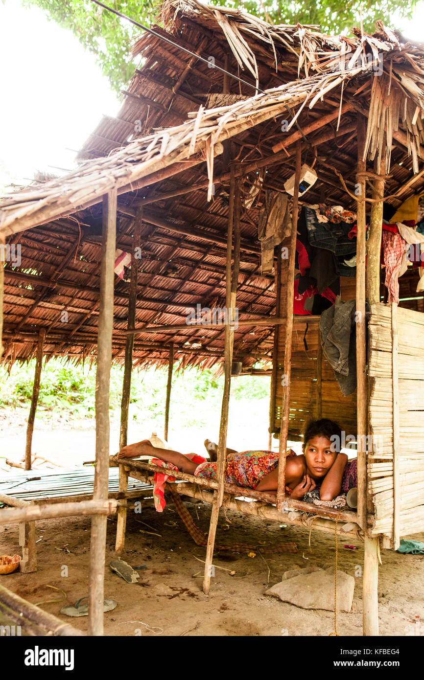PHILIPPINES, Palawan, Barangay region, young Batak woman rests in her ...