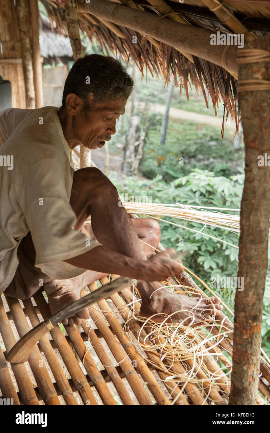 PHILIPPINES, Palawan, Barangay region, a Batak man shaves thin long ...