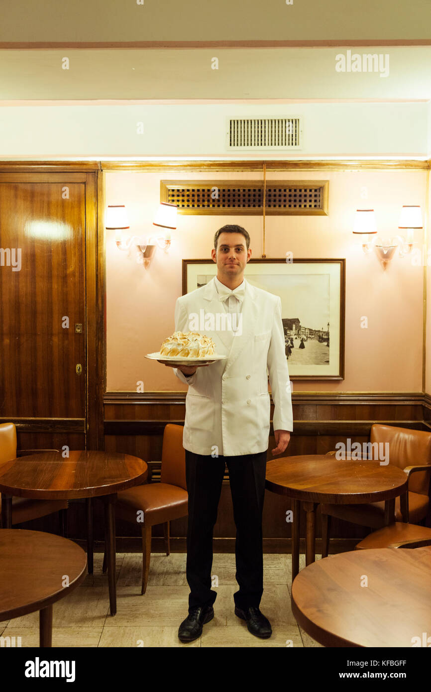 ITALY, Venice. A waiter holding a dessert at Harry's Bar Stock Photo ...