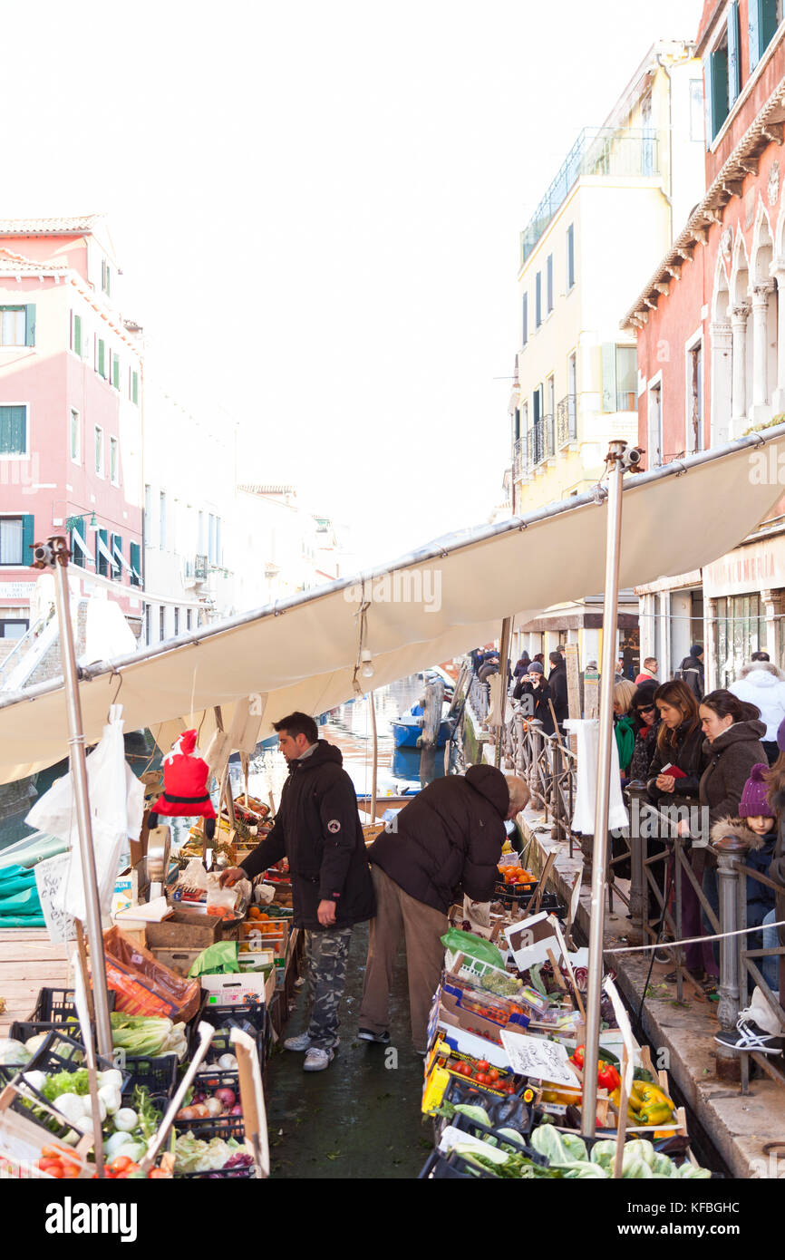 ITALY, Venice. Locals shopping at a floating produce market along a ...