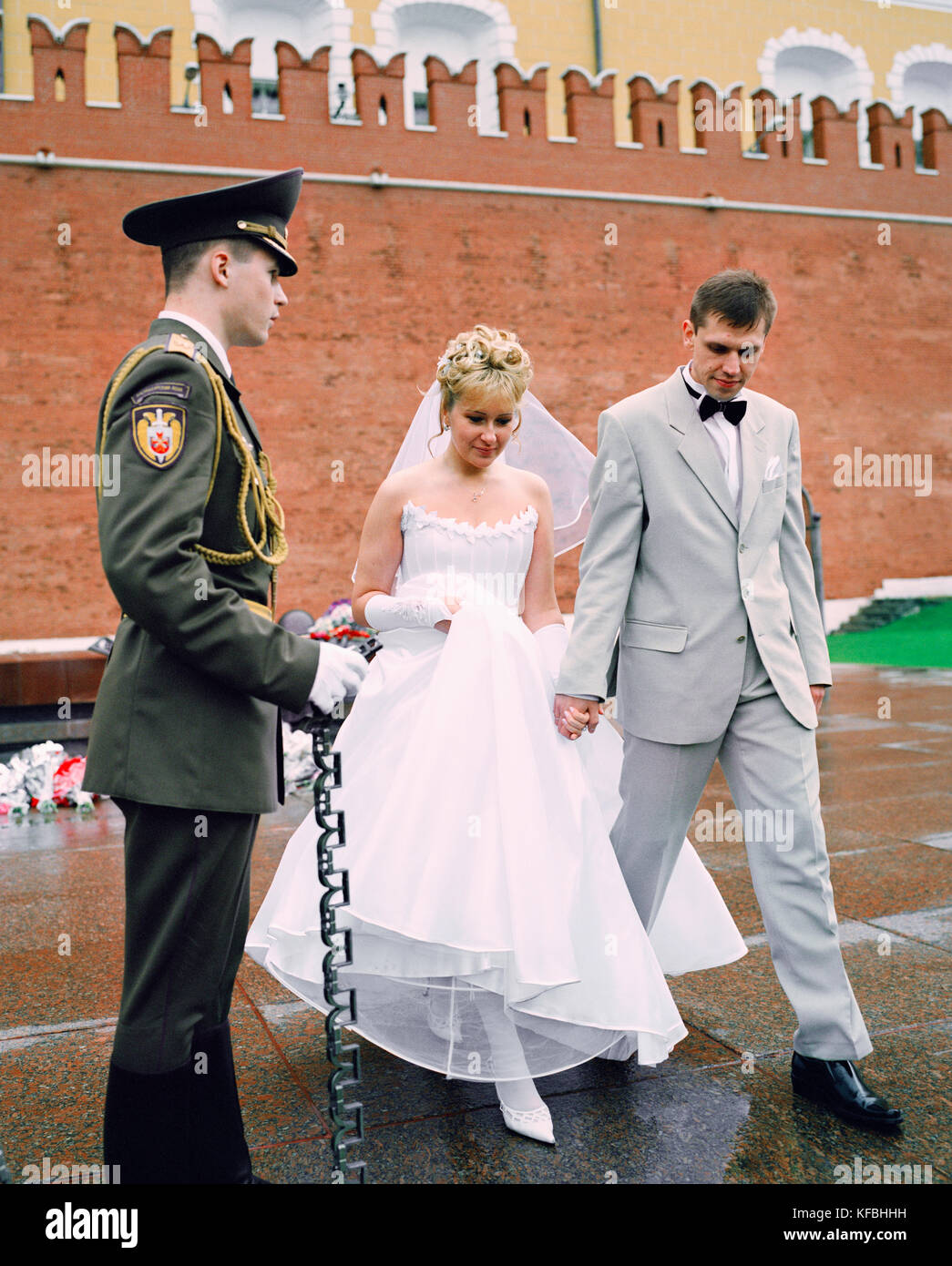 RUSSIA, Moscow, Kremlin, bride and groom holding hands and walking ...