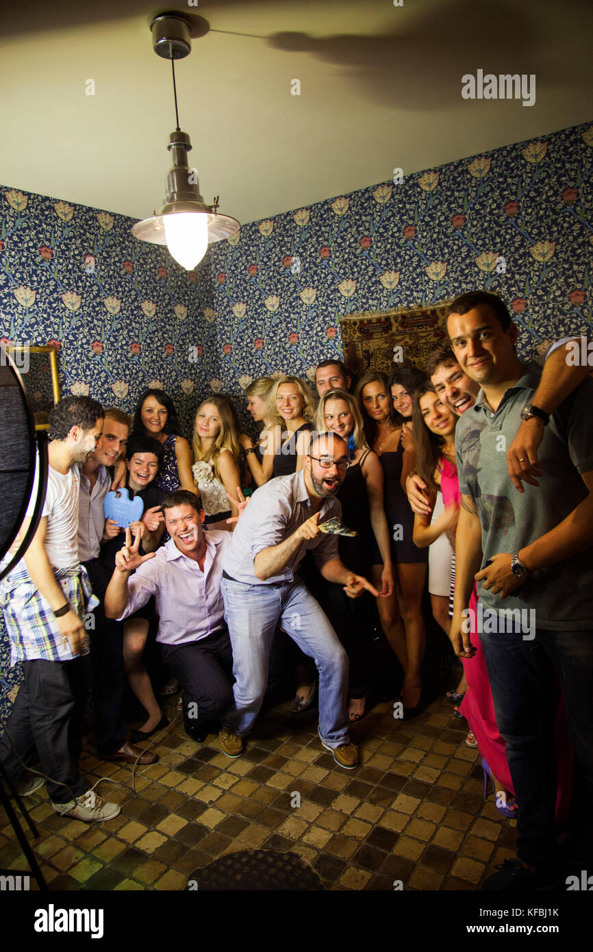 RUSSIA, Moscow. Group of friends posing for a picture at Delicatessen ...