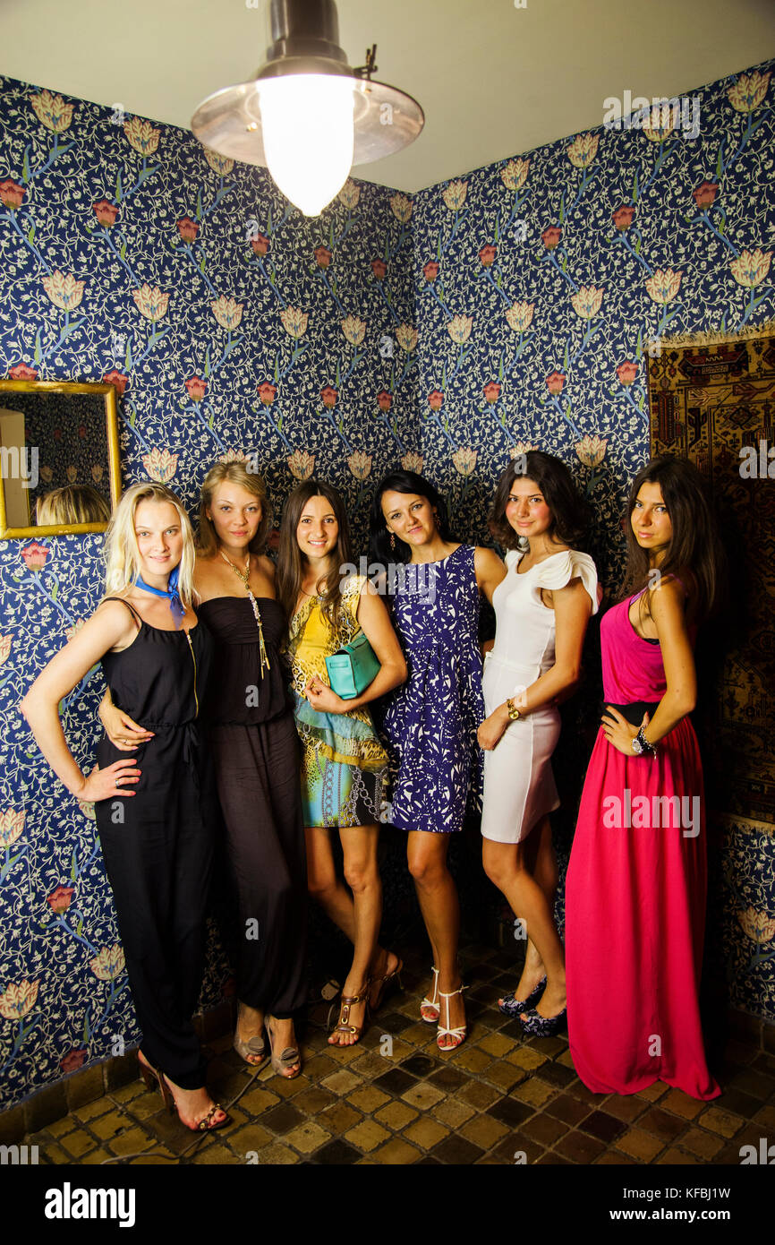 RUSSIA, Moscow. Group of friends posing for a picture at Delicatessen ...