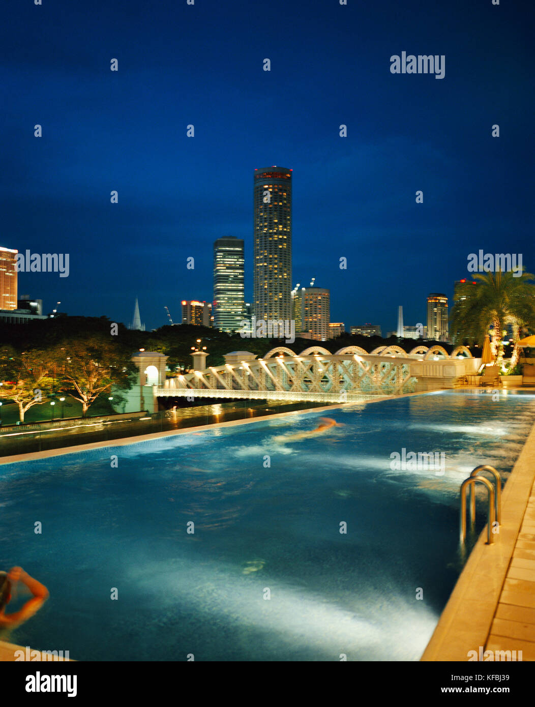 SINGAPORE, Asia, view of swimming pool at Fullerton hotel at night with ...