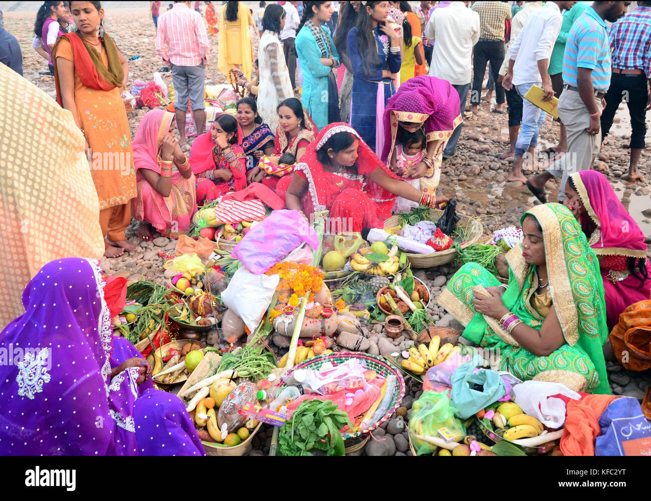 An Indian devotee receives a Tika, a red mark on her forehead, as she ...
