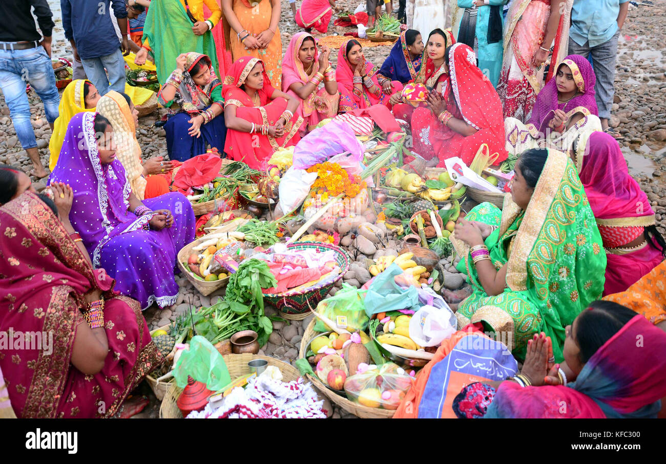 An Indian devotee receives a Tika, a red mark on her forehead, as she ...