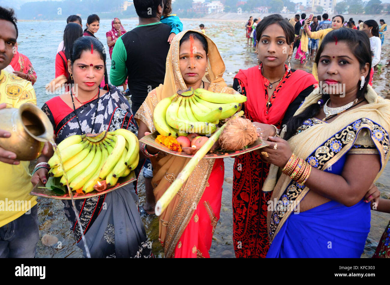 An Indian devotee receives a Tika, a red mark on her forehead, as she ...
