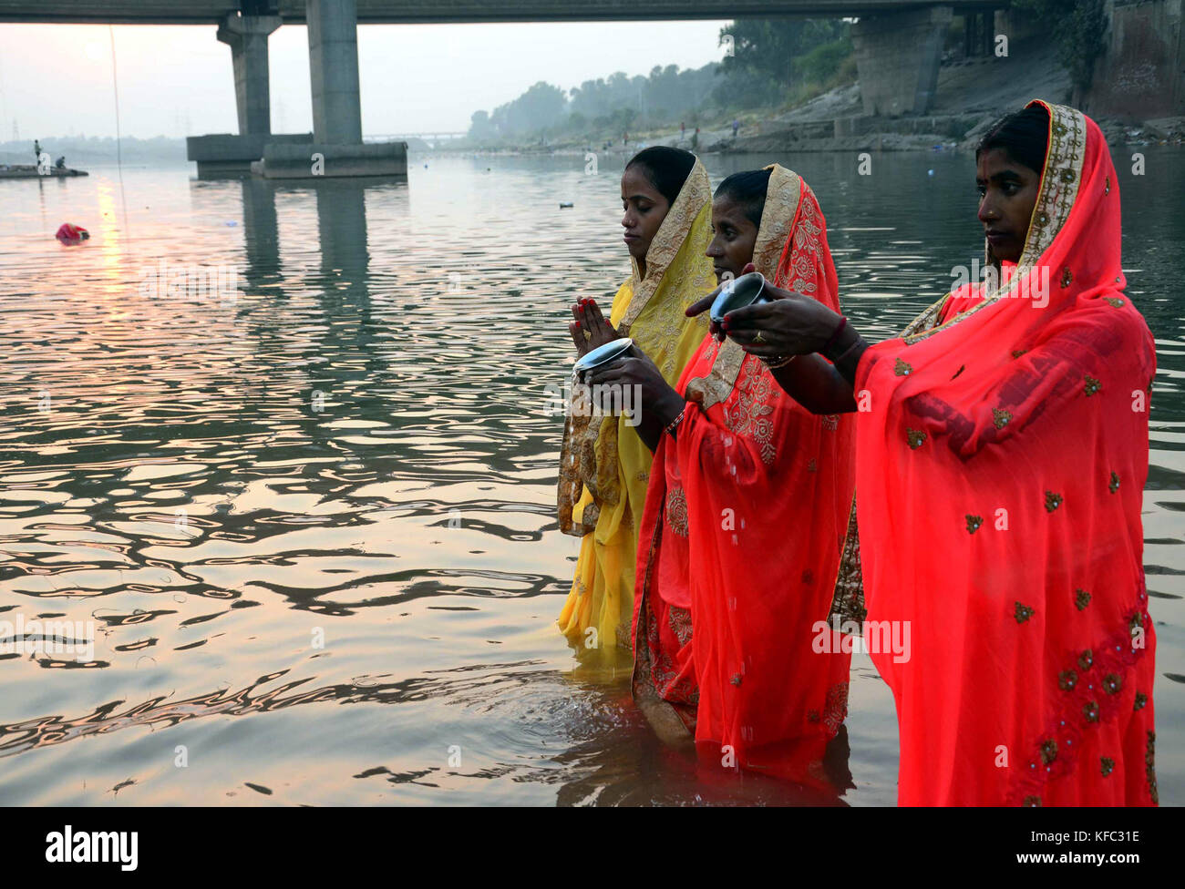An Indian devotee receives a Tika, a red mark on her forehead, as she ...