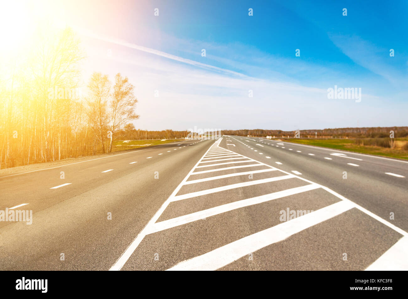 The picturesque landscape and the Sunrise over the road. Asphalt road ...
