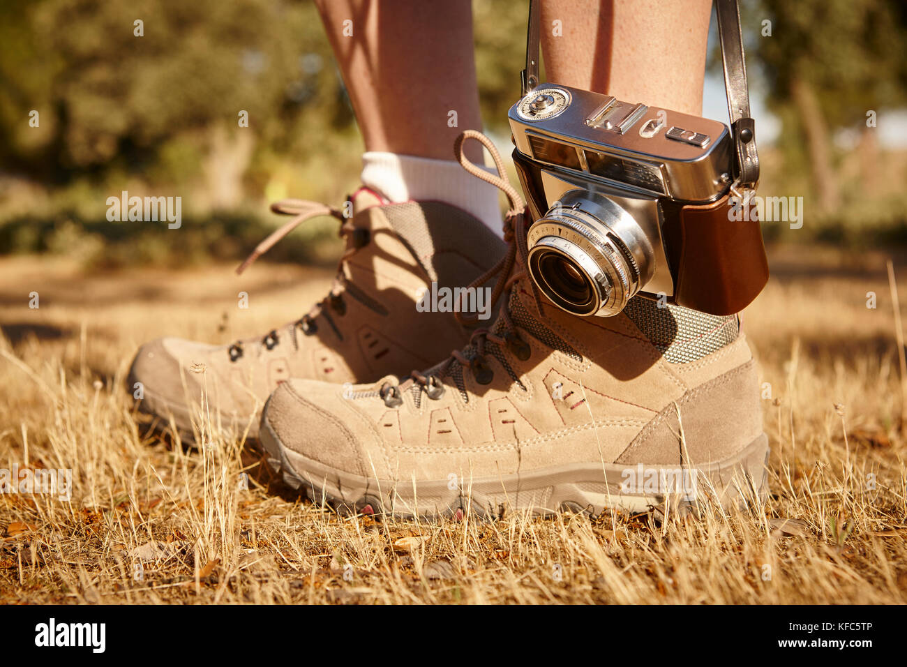 Vintage camera with hiking boots on the ground. Travel background Stock ...