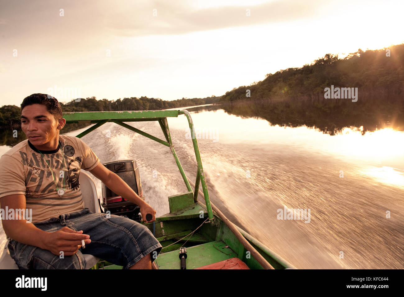 BRAZIL, Amazon Jungle, fly fishing guide racing back to the lodge at ...