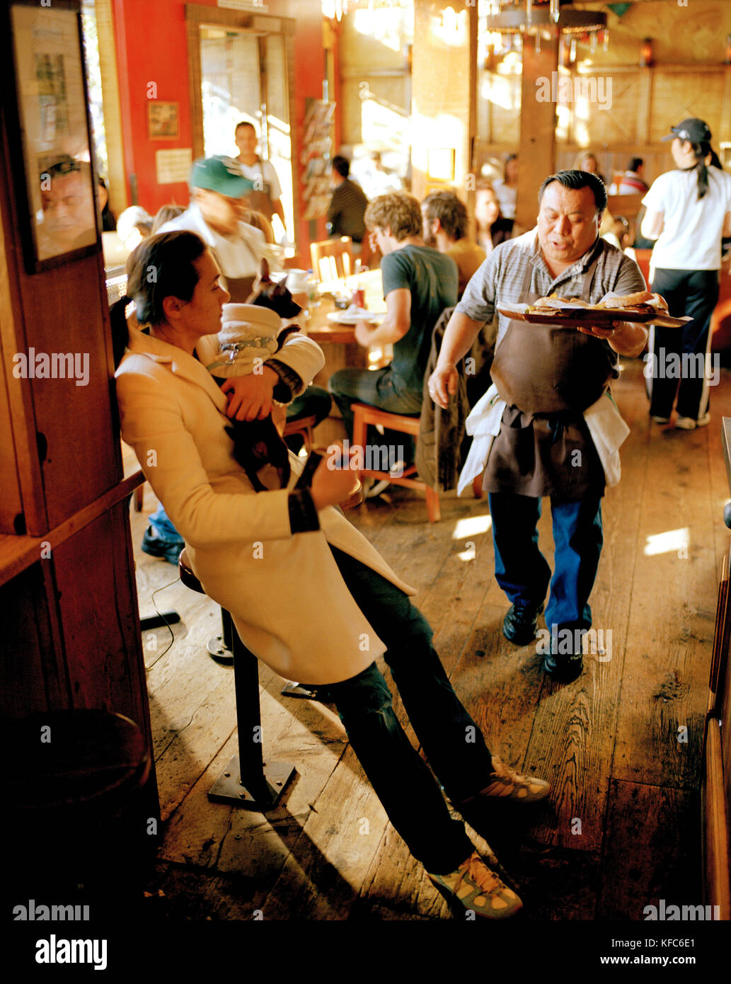 USA, California, San Francisco, a woman and her dog wait for a table to ...