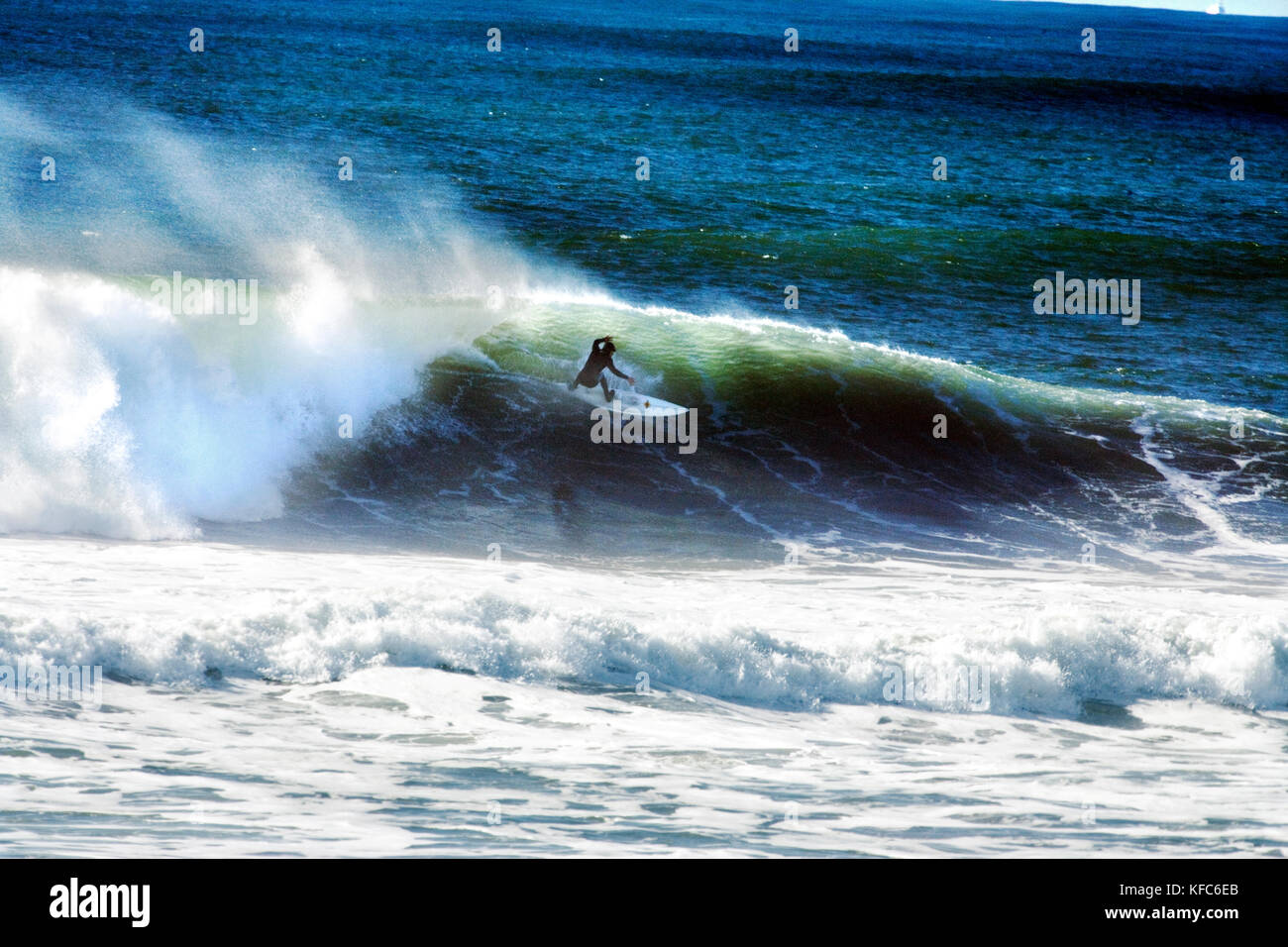 USA, California, San Francisco, man surfing on a wave at Ocean Beach ...