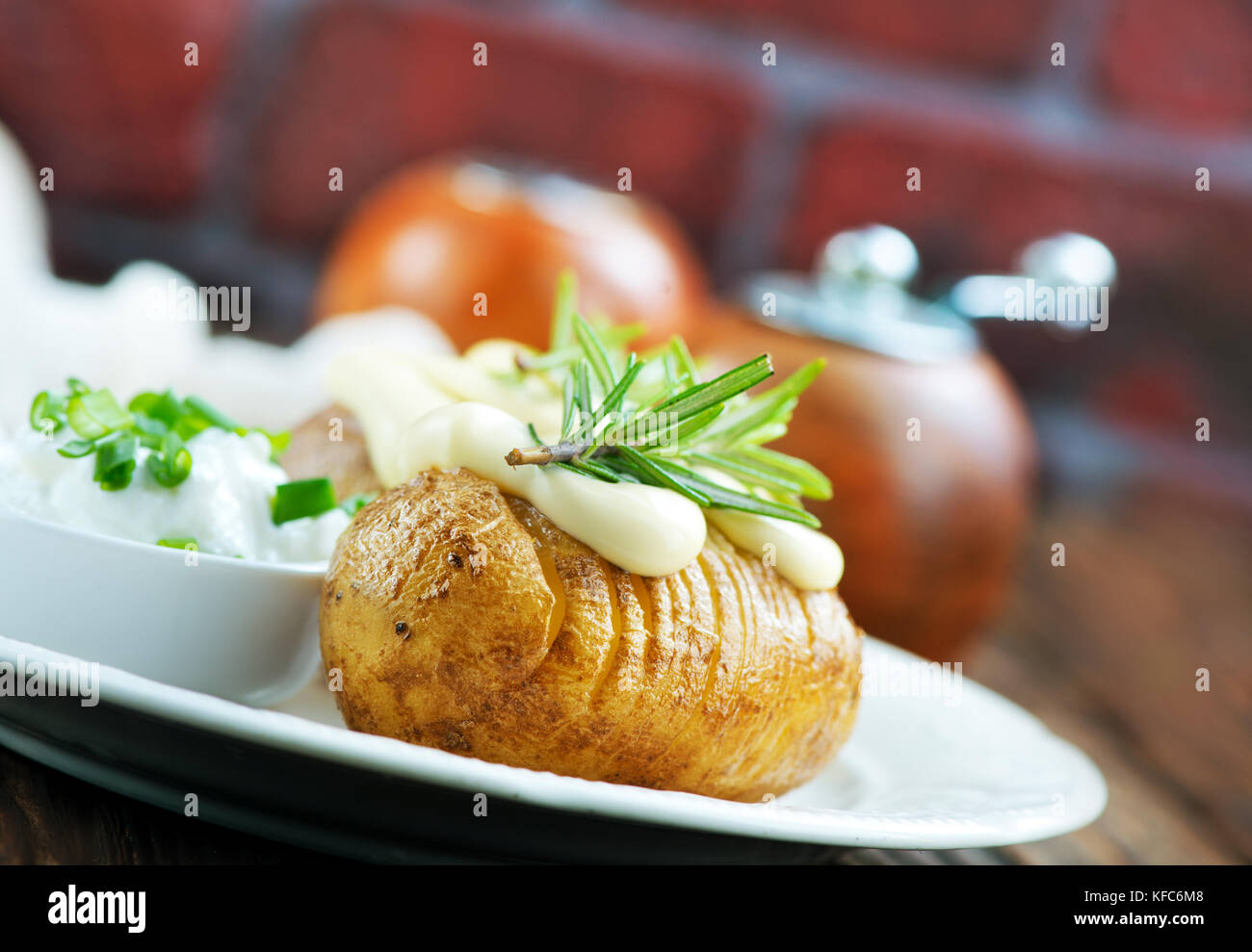 baked potato on plate and on a table Stock Photo - Alamy