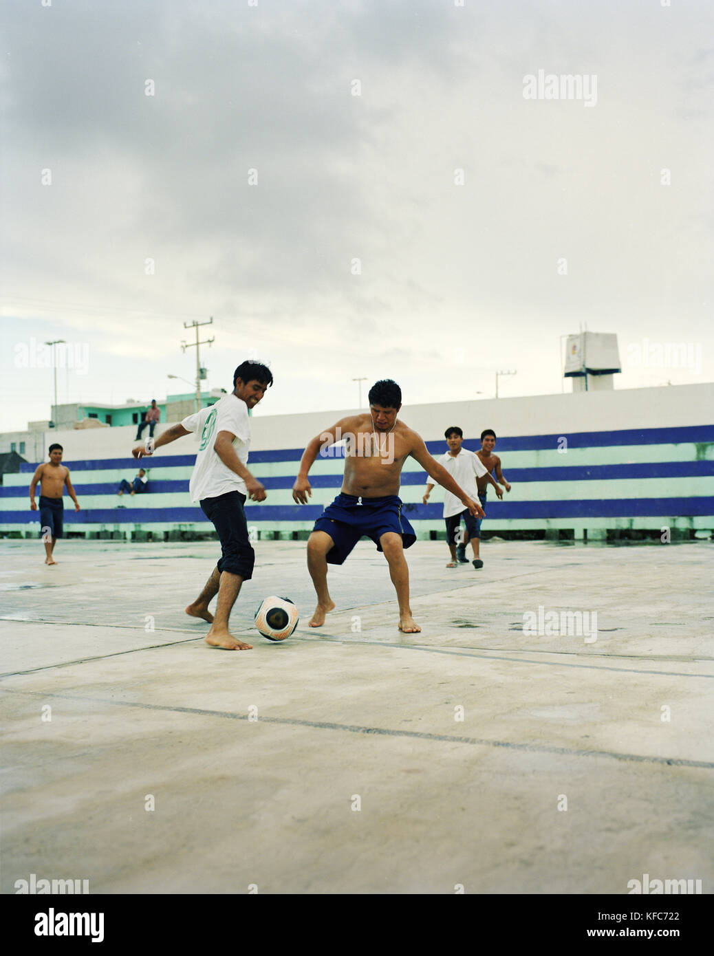 MEXICO, Maya Riviera, Yucatan Peninsula, young men play soccer in the ...