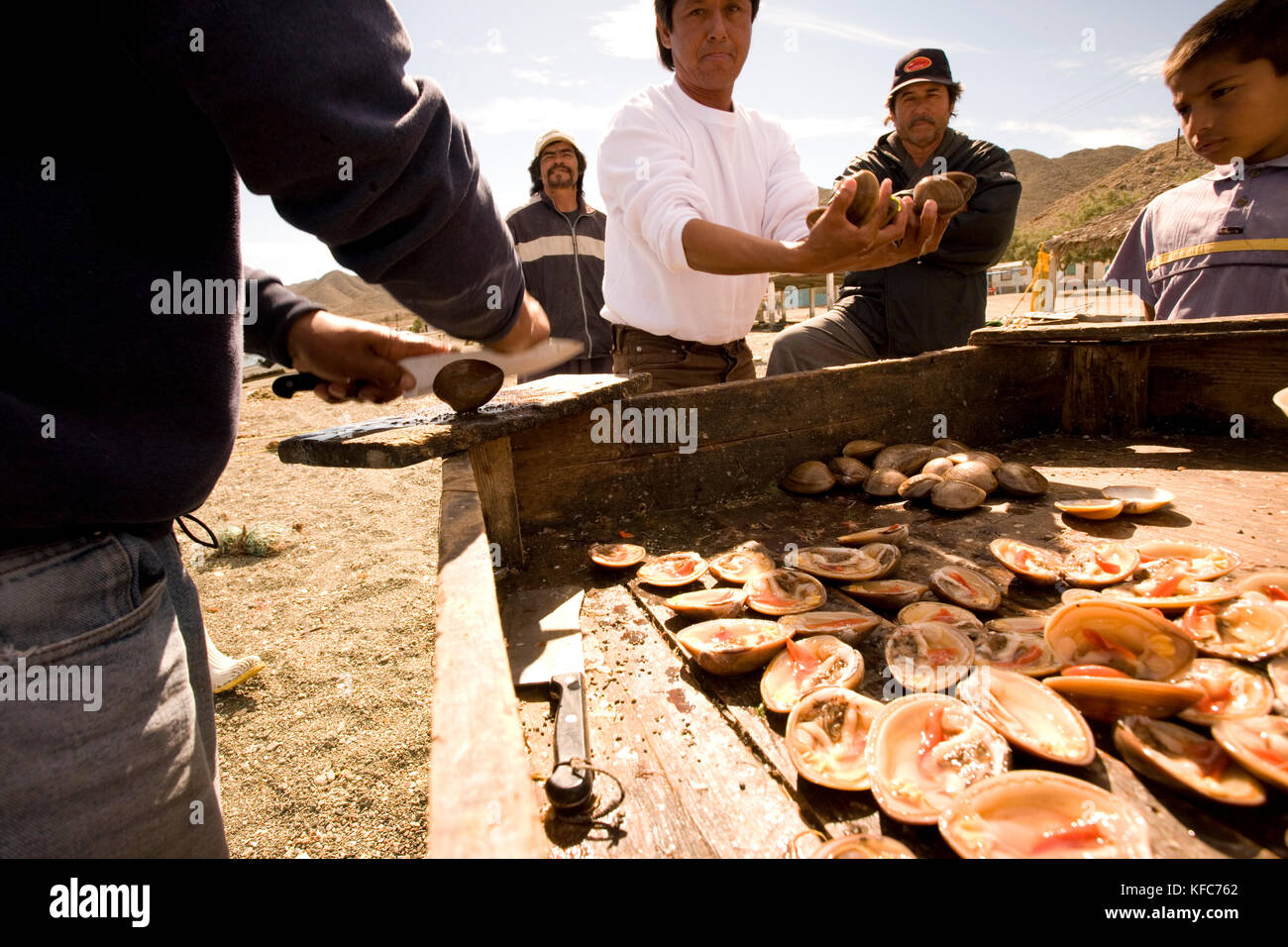 MEXICO, Baja, Magdalena Bay, Pacific Ocean, men cooking shellfish Stock ...