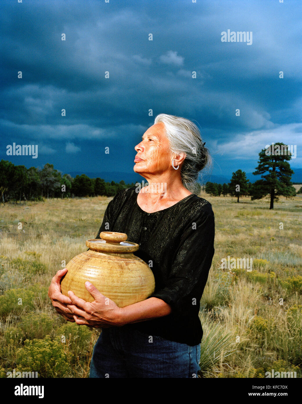 USA, New Mexico, beautiful Native American woman holding a pot, Valley ...
