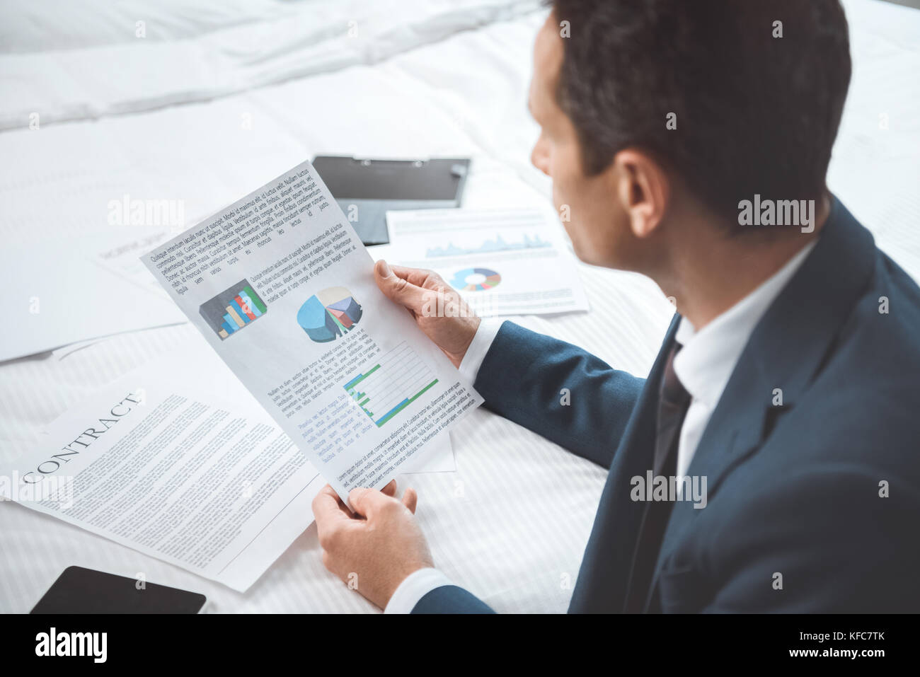 businessman reading paperwork Stock Photo - Alamy