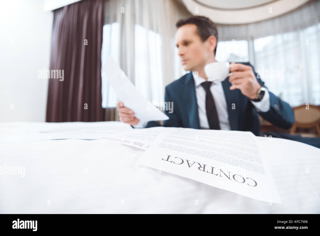 businessman reading paperwork Stock Photo - Alamy