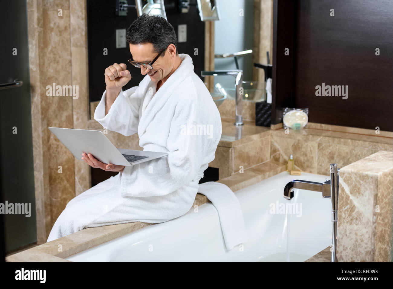 Use the laptop in the bathroom hi-res stock photography and images - Alamy