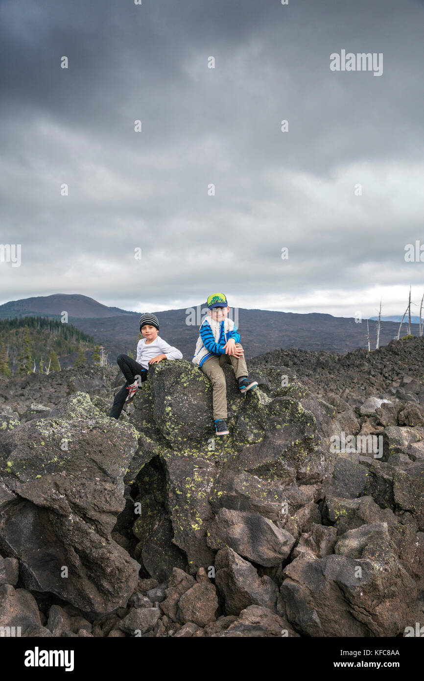 Two children playing on rocks hi-res stock photography and images - Alamy